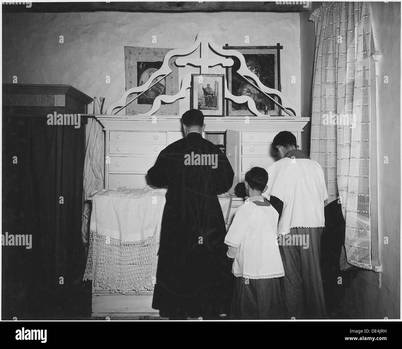 Father Morgan is shown preparing for Mass by putting on vestments in ...