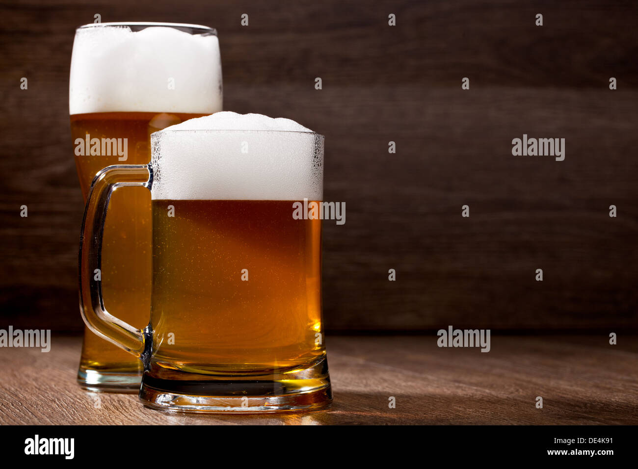 Two glass beer on wooden table Stock Photo - Alamy