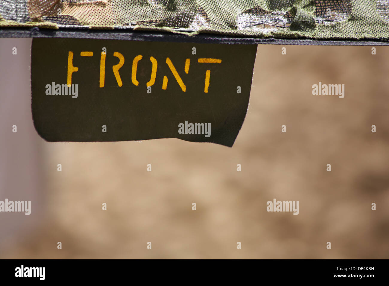 Front tag hanging from camouflage material on beach Stock Photo - Alamy