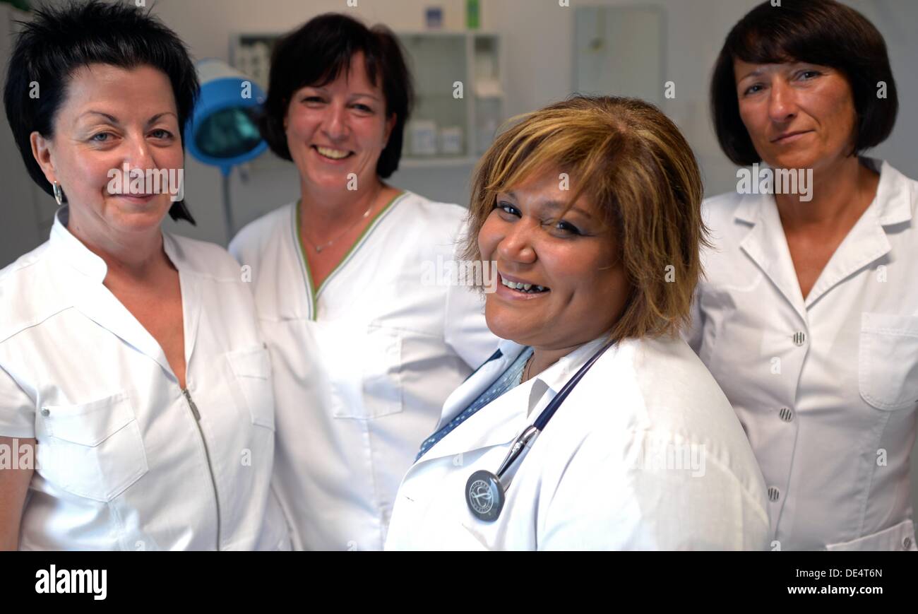 US doctor Elizabeth Beltre (2-R) poses for the camera with assistants ...