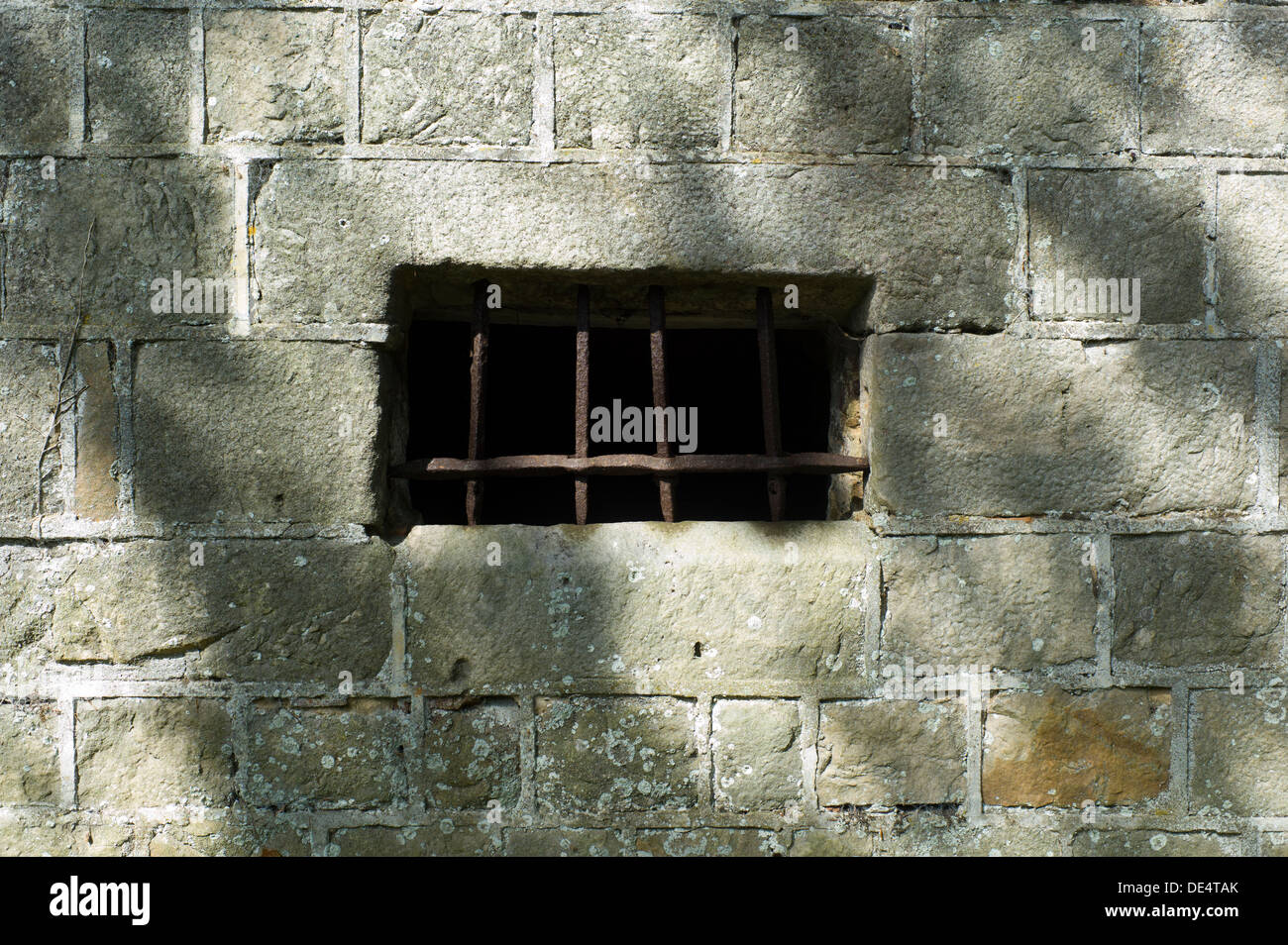 Barred window, metal grille, stone wall and shadows Stock Photo - Alamy