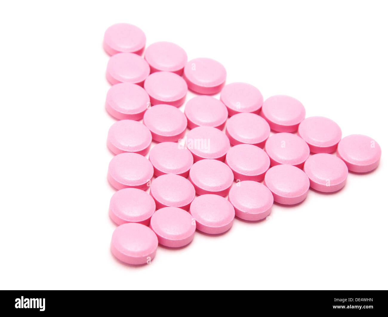 Pink tablets on a white background Stock Photo - Alamy