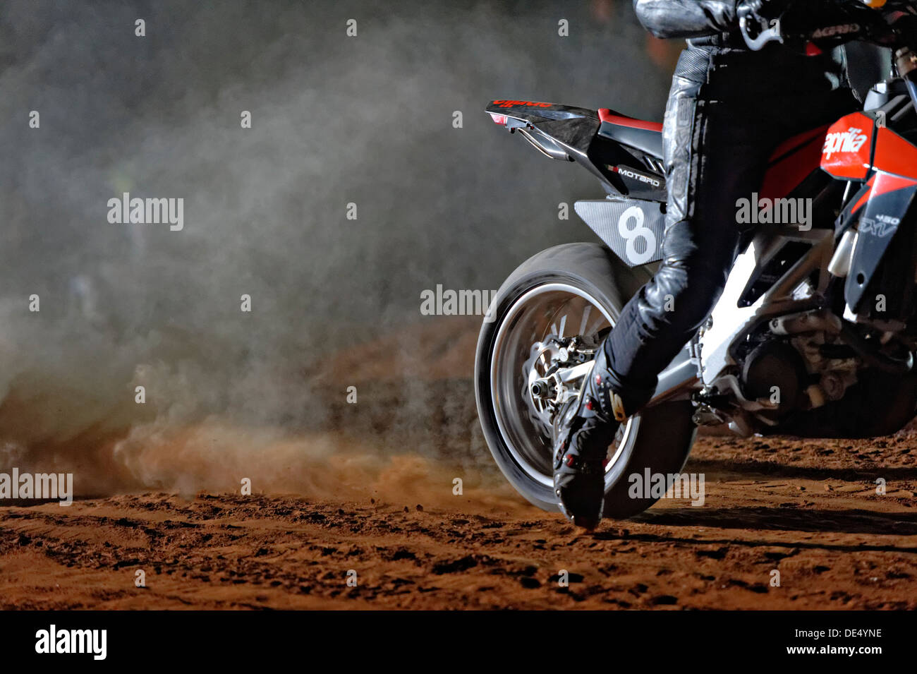 A motocross bike rear wheel spinning on the spot in a sand track ...