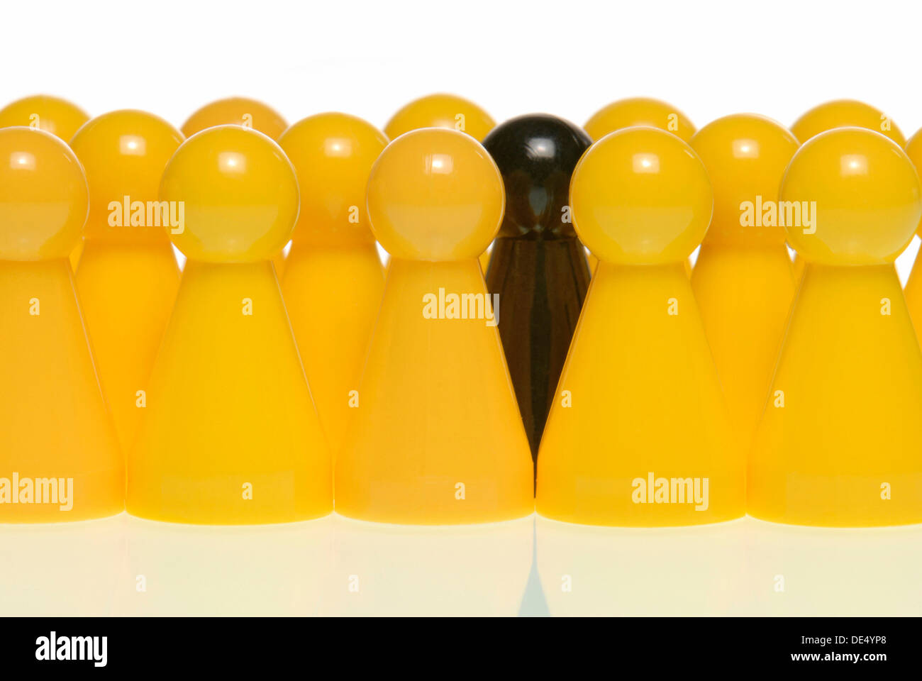 A black figure surrounded by yellow figures, symbolic image for the ...