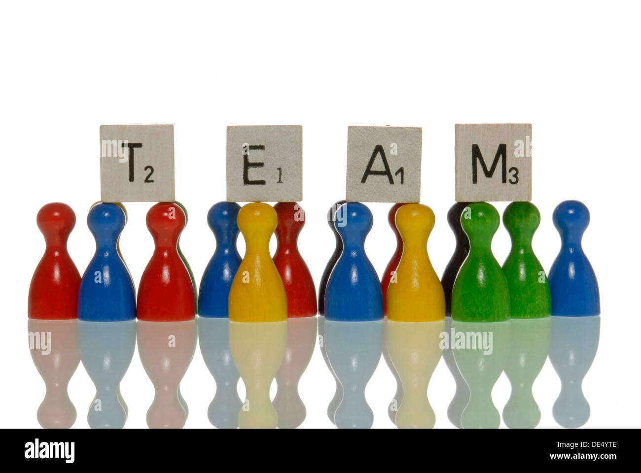 Game figures and letter tiles, spelling the word team Stock Photo - Alamy
