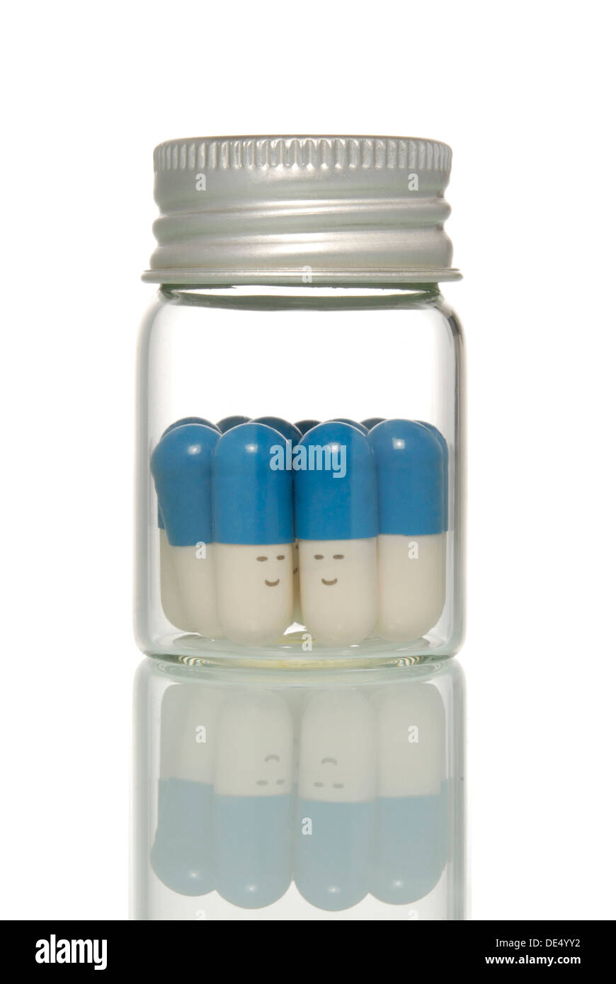 Capsules in a glass, two with a face Stock Photo - Alamy