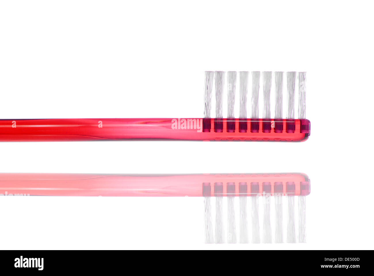 Red toothbrush with reflections Stock Photo - Alamy