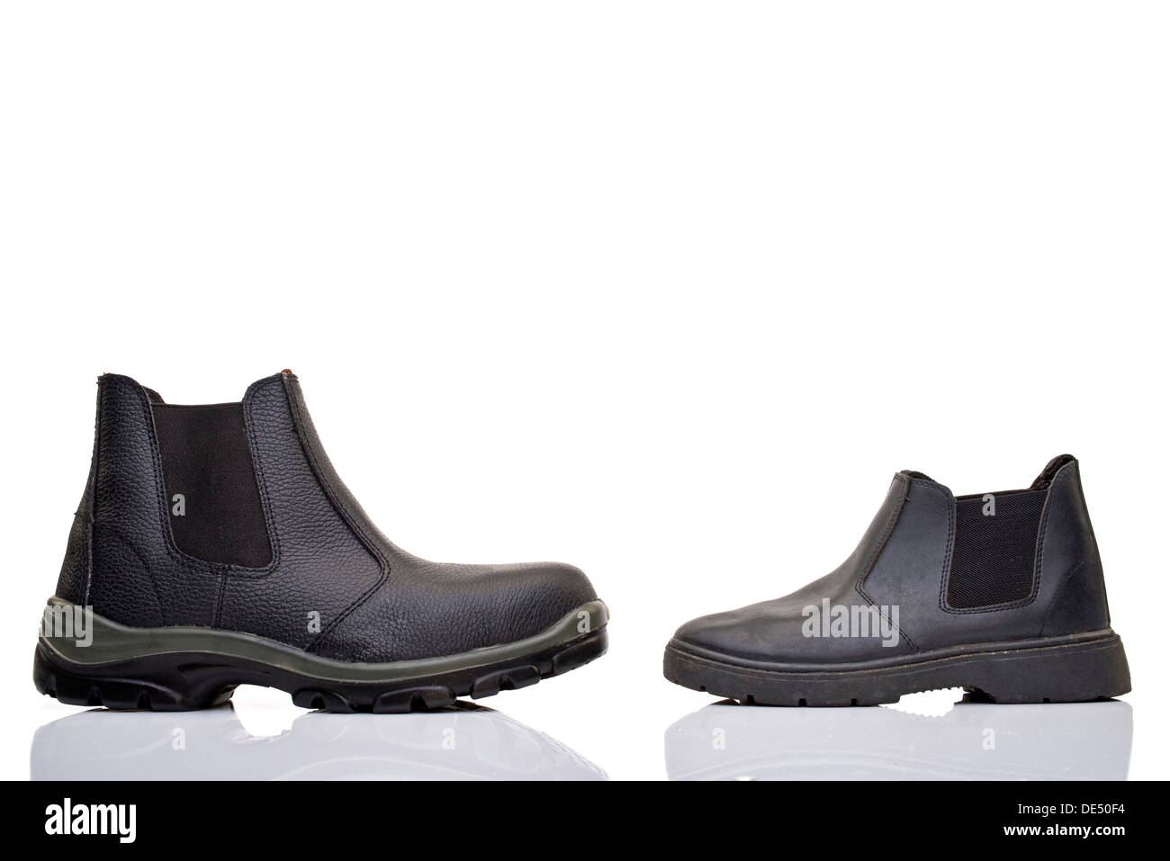 Large workman's shoe facing a smaller workman's shoe Stock Photo - Alamy