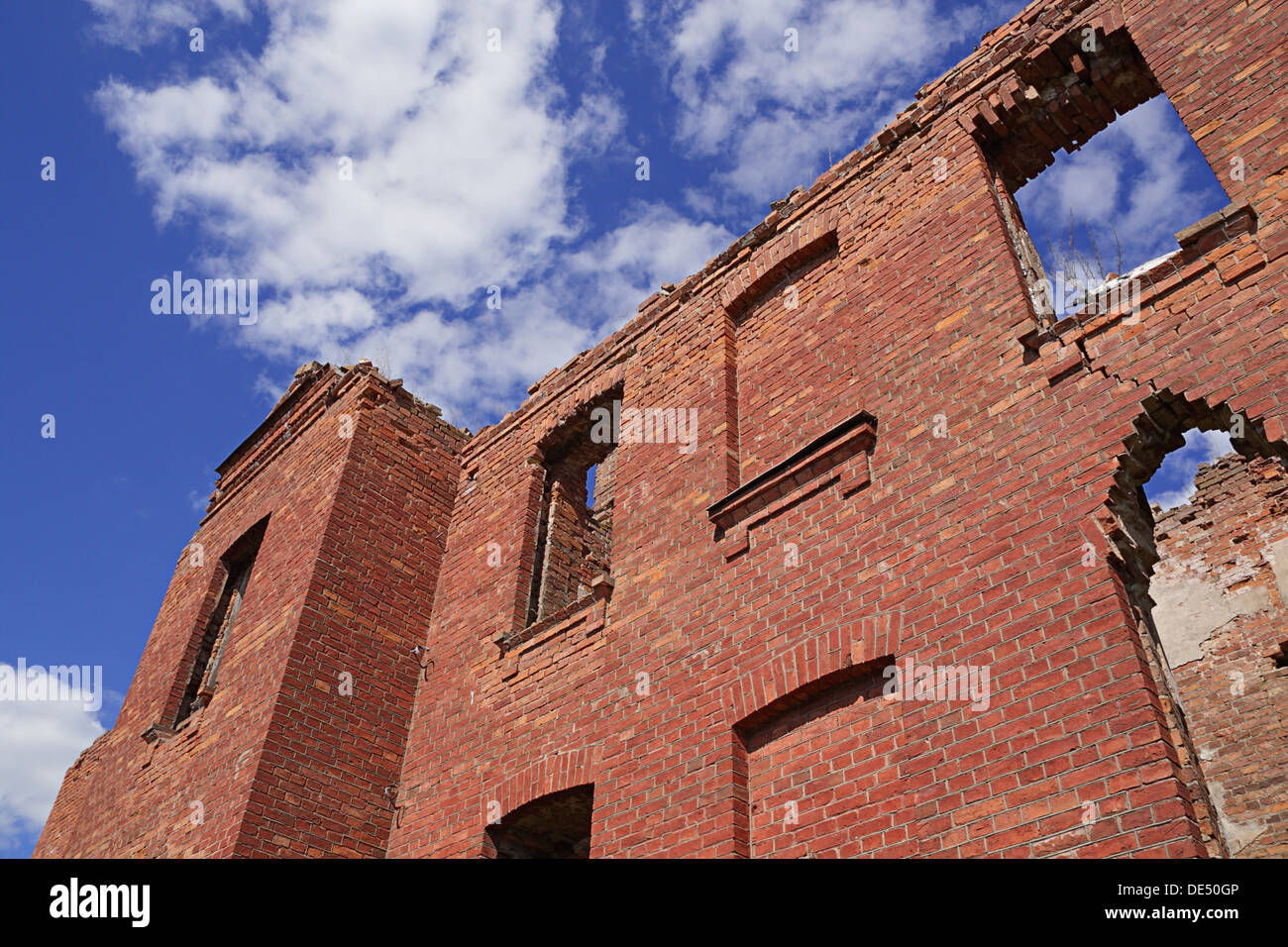 Blue sky and collapsing brick wall of antique building Stock Photo - Alamy