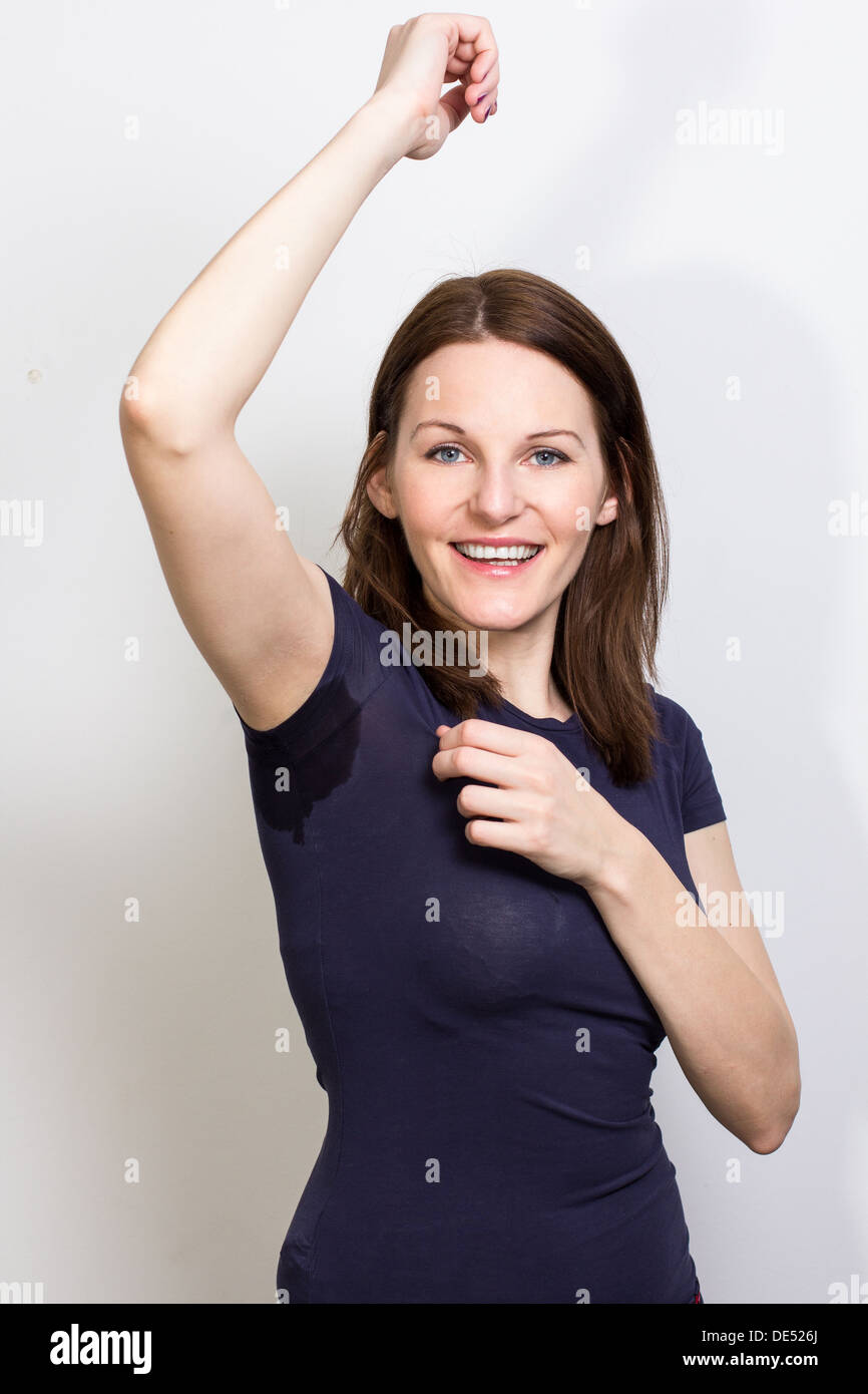 Woman sweating very badly under armpit Stock Photo - Alamy