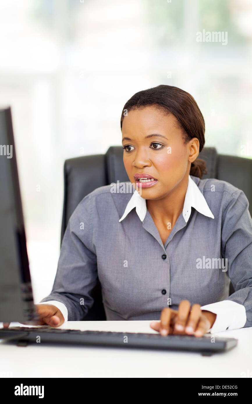 surprised African office worker working on computer Stock Photo - Alamy