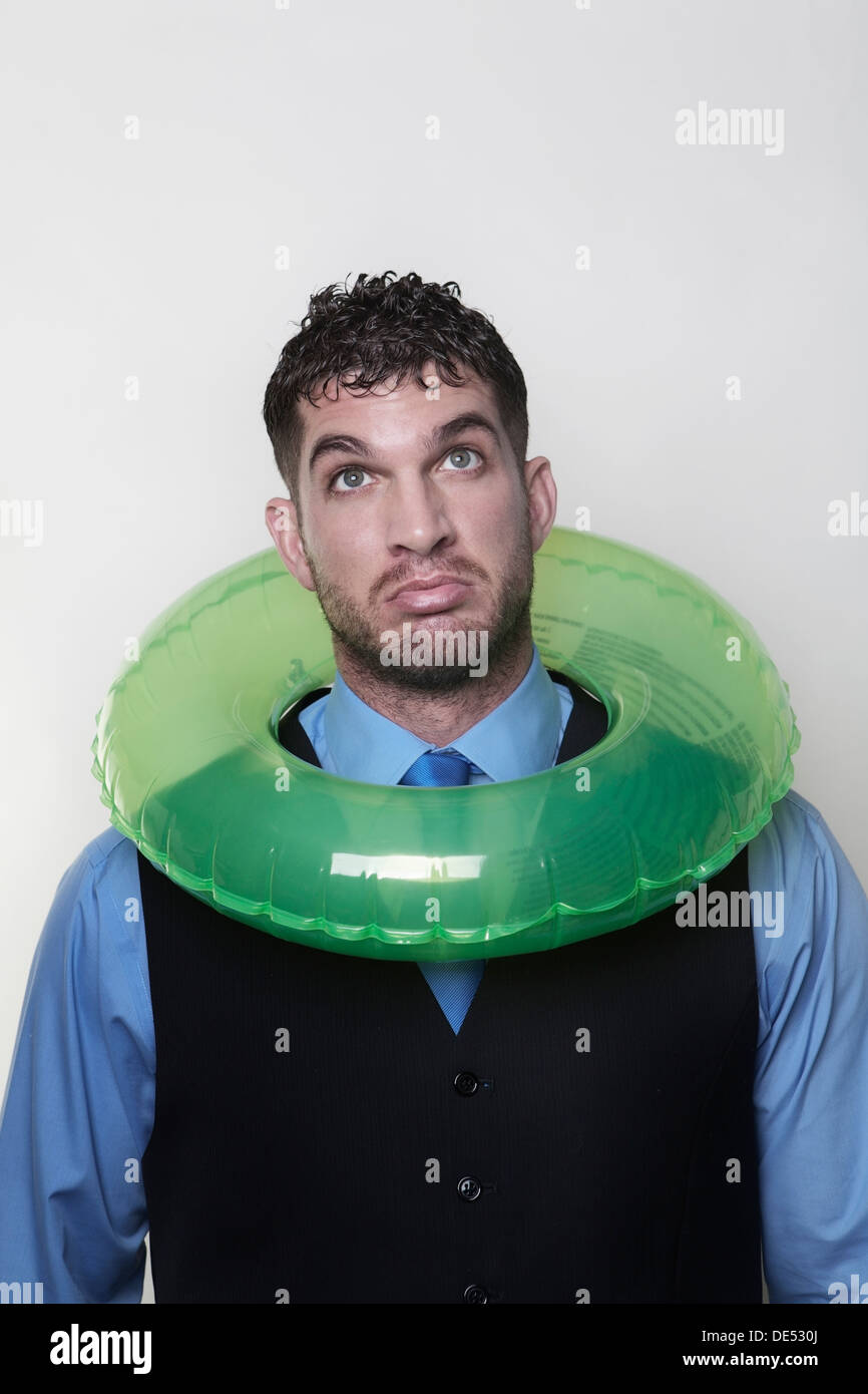 handsome business type man with a kids rubber ring around his neck ...