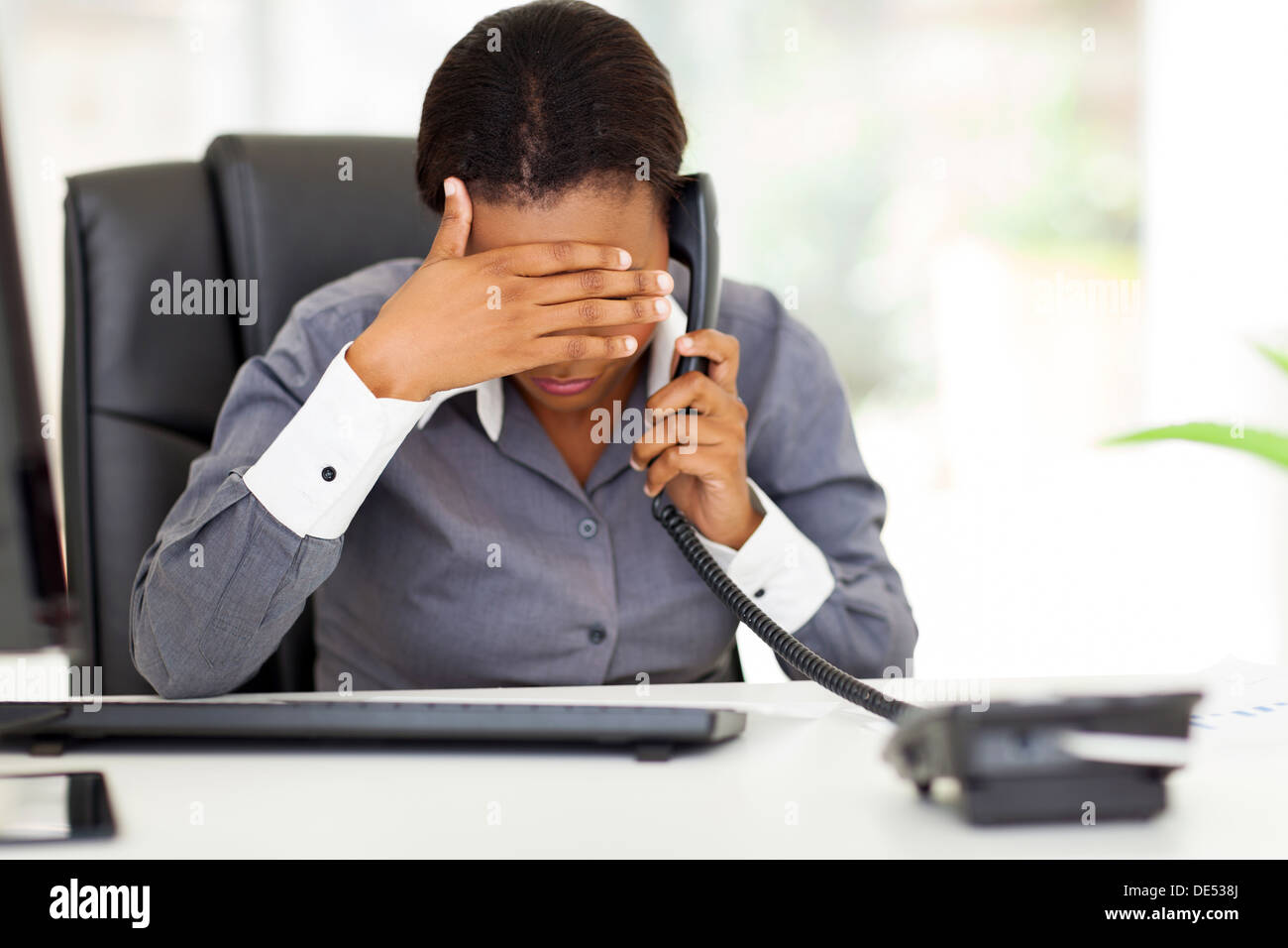 tired African American businesswoman using landline phone Stock Photo ... tired African American businesswoman using landline phone Stock Photo ...