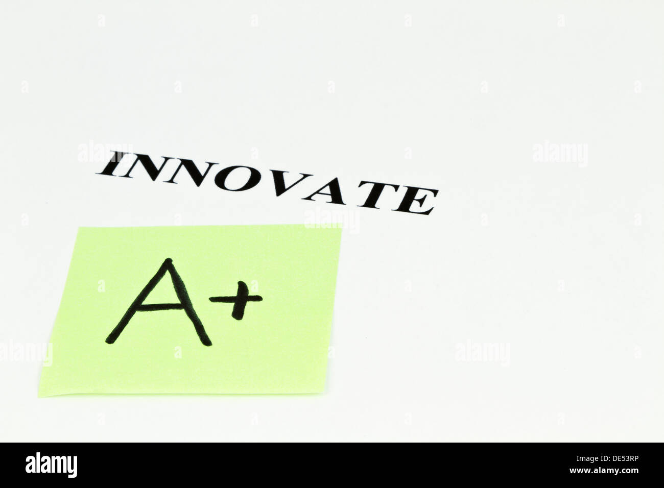 A+ grade note placed next to word, INNOVATE, on white background with ...