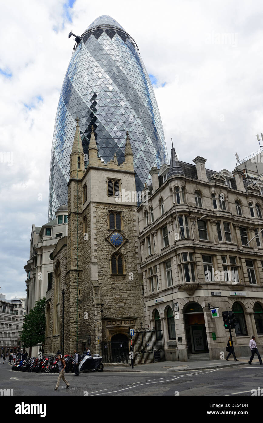 The Gherkin building peaking from behind an old historic building and ...