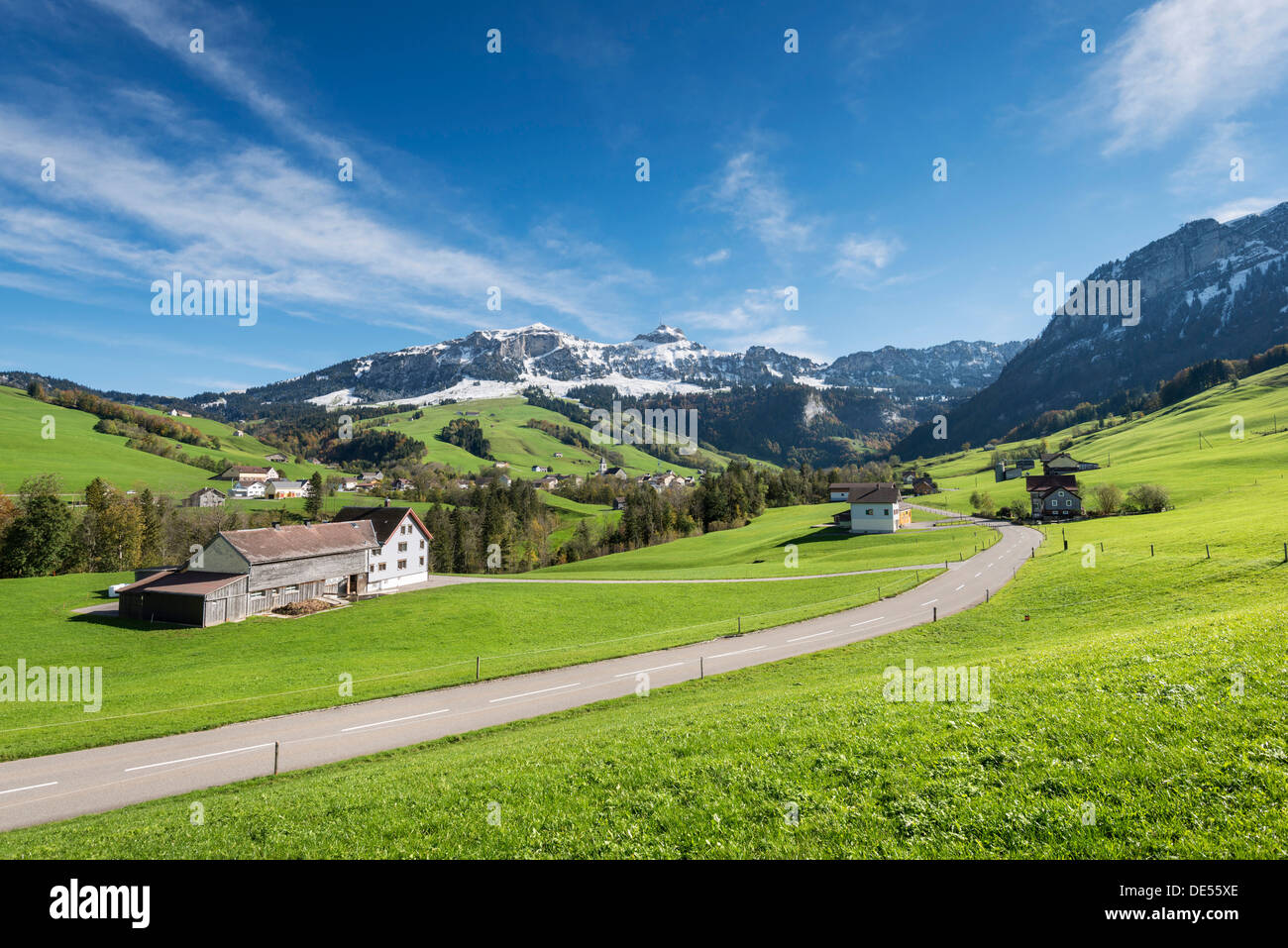 Green pastures in Appenzellerland in front of the snow-capped Appenzell ...