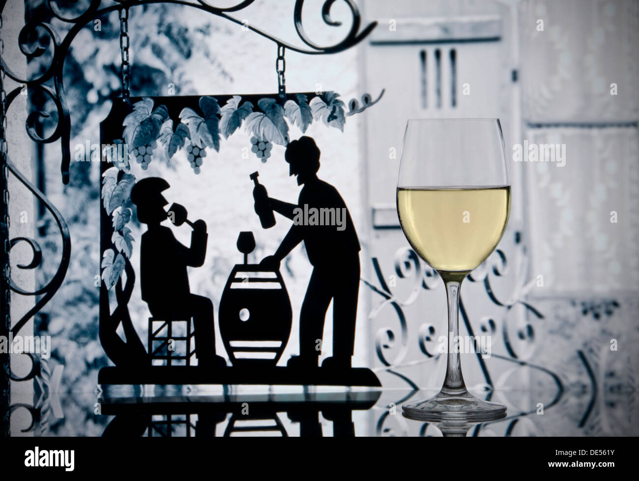 White wine glass on french bar café table with wine tasting sign ...