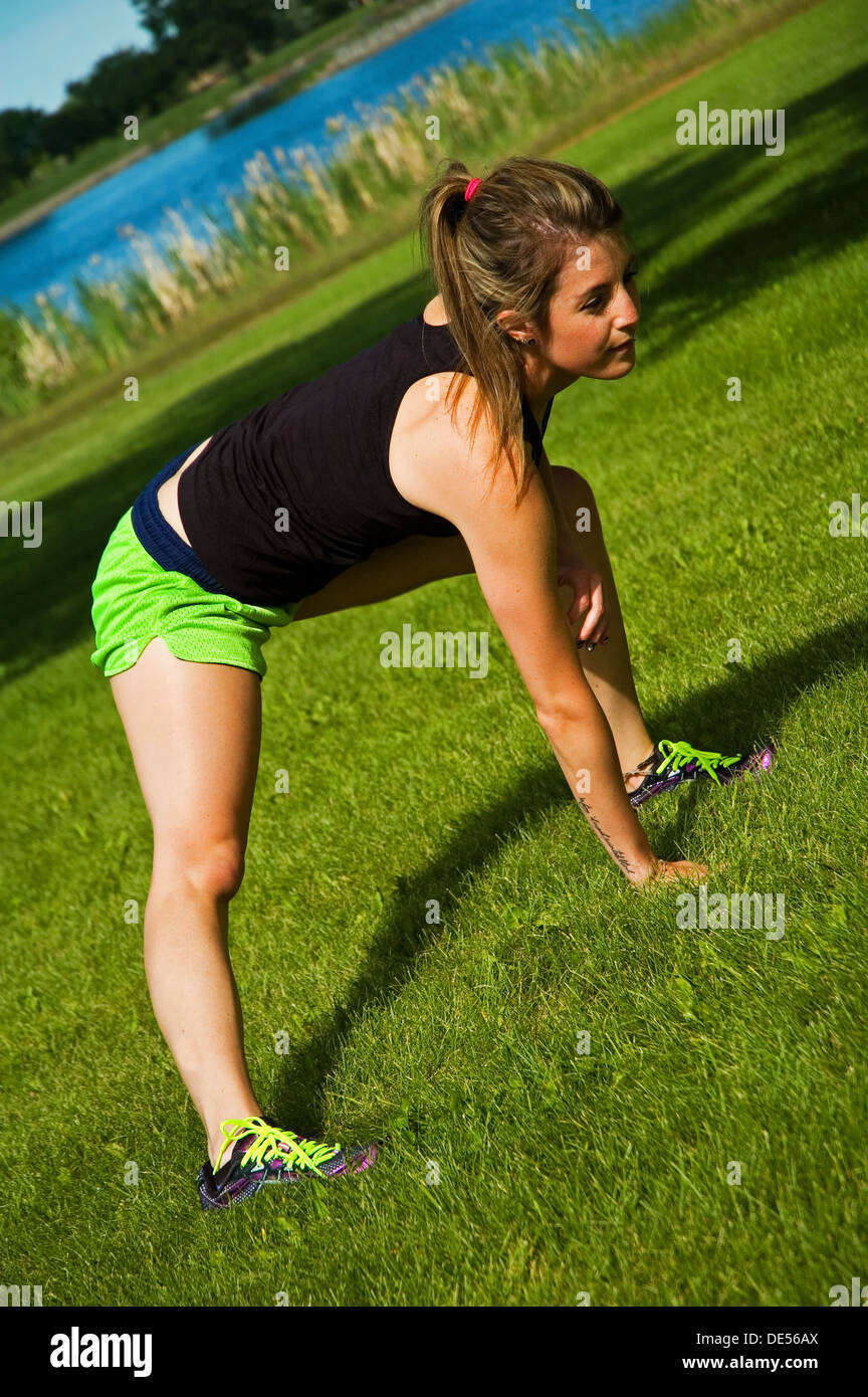 Young woman stretching her hamstrings and groin Stock Photo - Alamy
