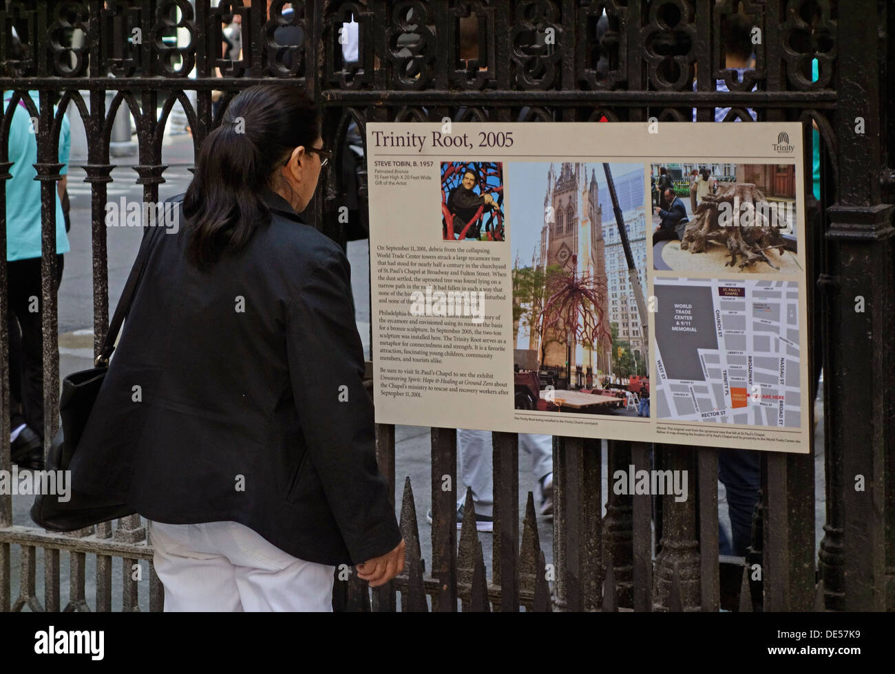 woman reading sign outside Trinity Church graveyard Stock Photo - Alamy