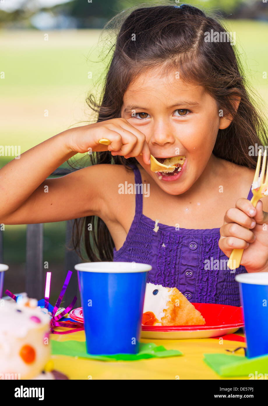 Happy Young Girl Eating Cake at Birthday Party Stock Photo - Alamy