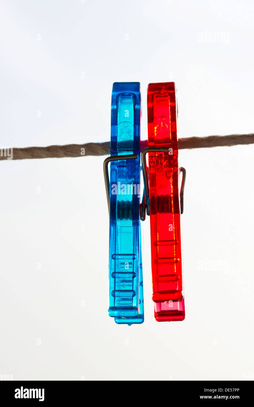 Red and blue pegs on a clothesline Stock Photo - Alamy