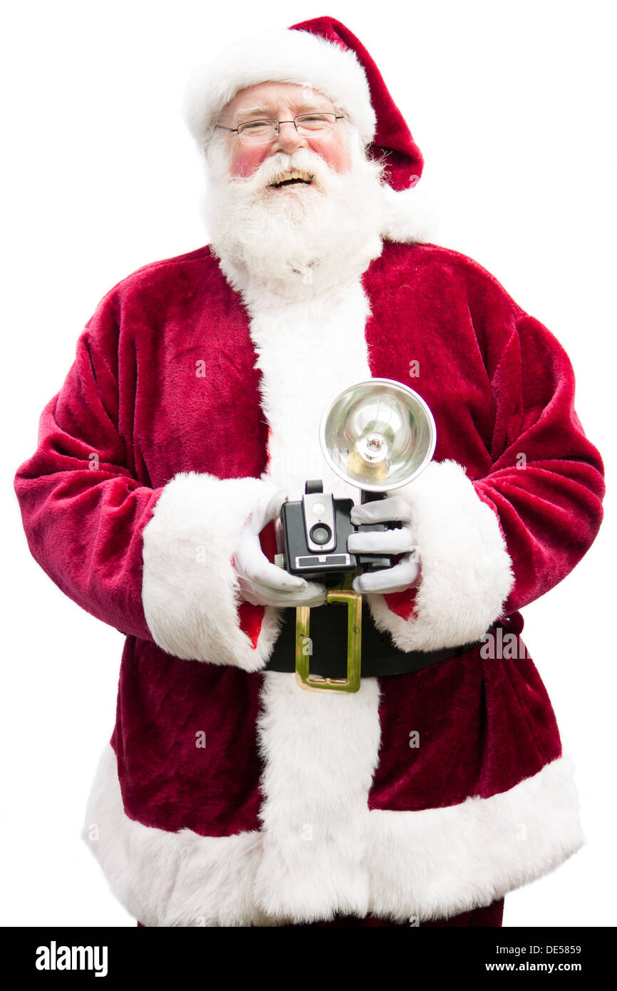 Santa Claus holding a vintage camera laughs, looking into the camera ...