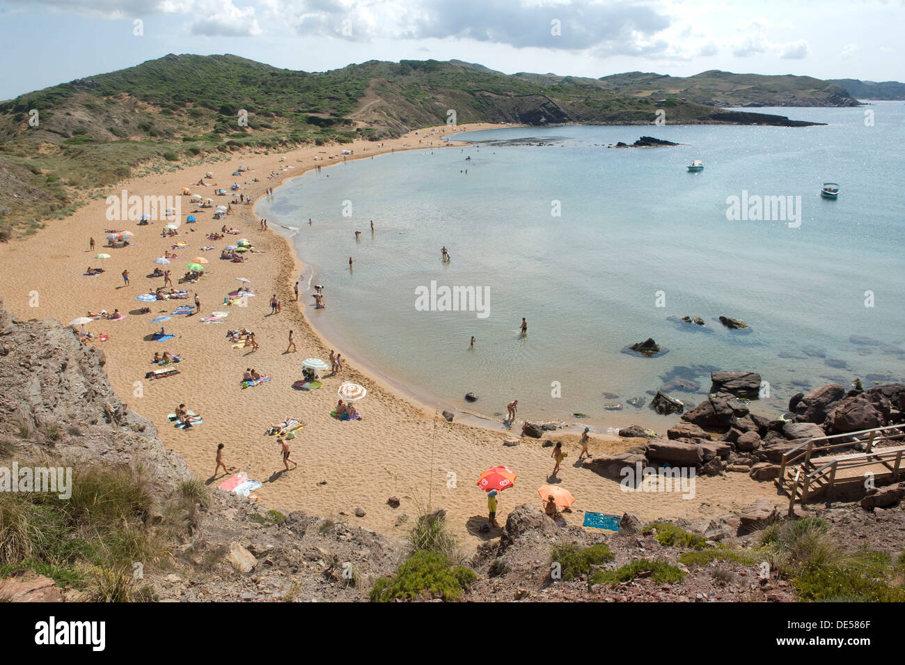 Tourists chill or sunbath in the beach in the Spanish Balearic islands ...