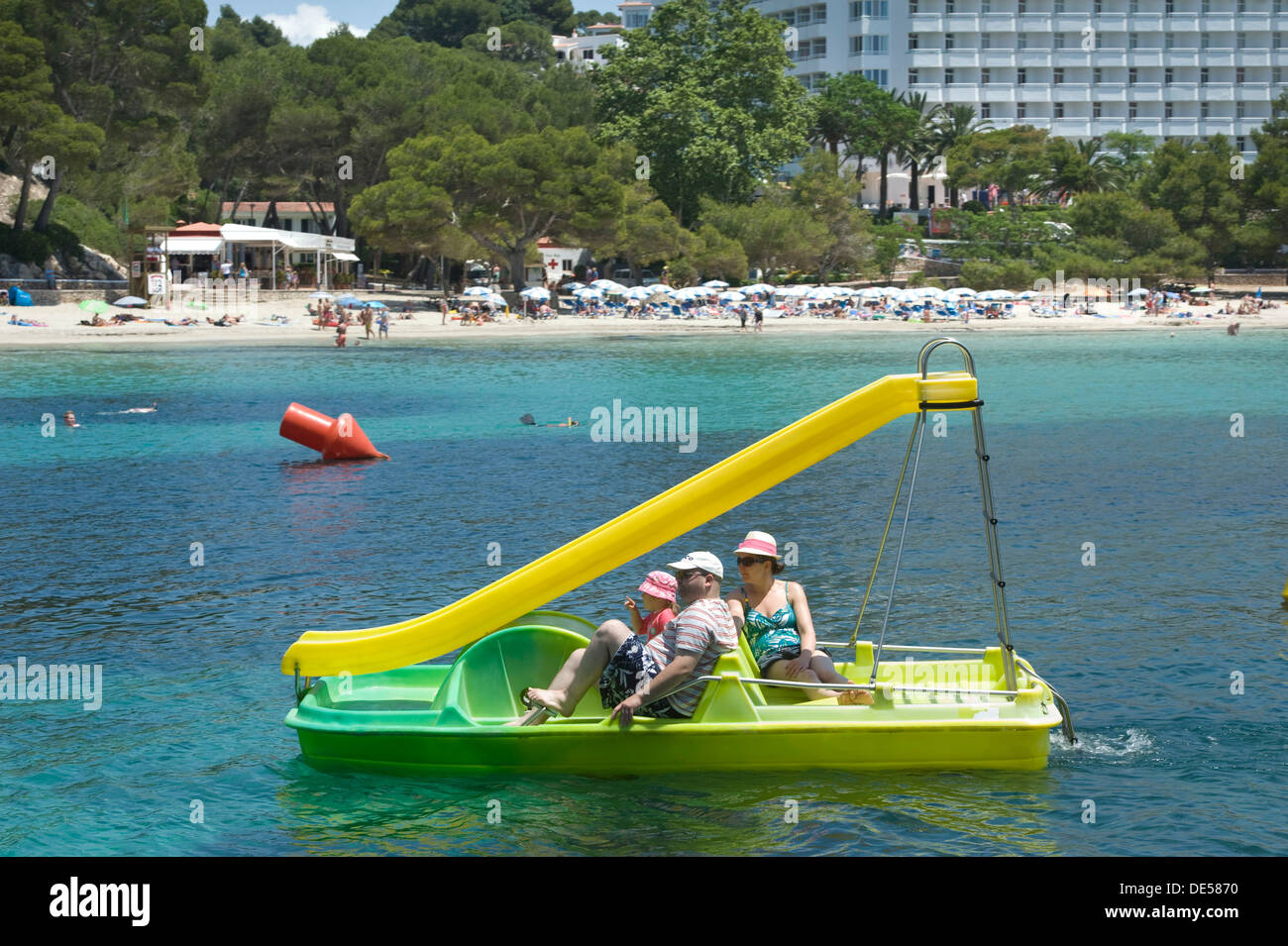 Tourists chill or sunbath in the beach in the Spanish Balearic islands ...