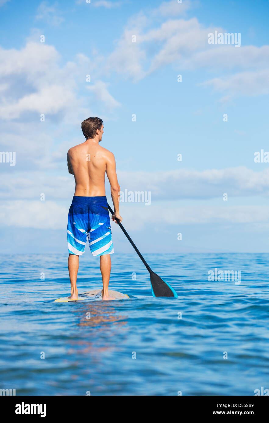 Young Attractive Mann on Stand Up Paddle Board, SUP, in the Blue Waters ...