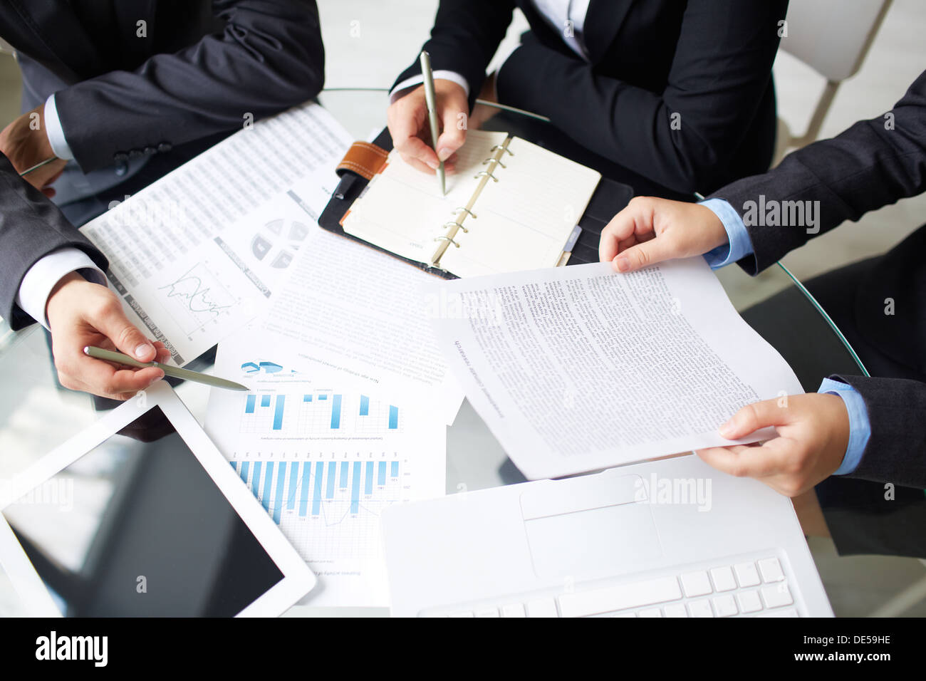 Image of human hands during paperwork at meeting Stock Photo - Alamy