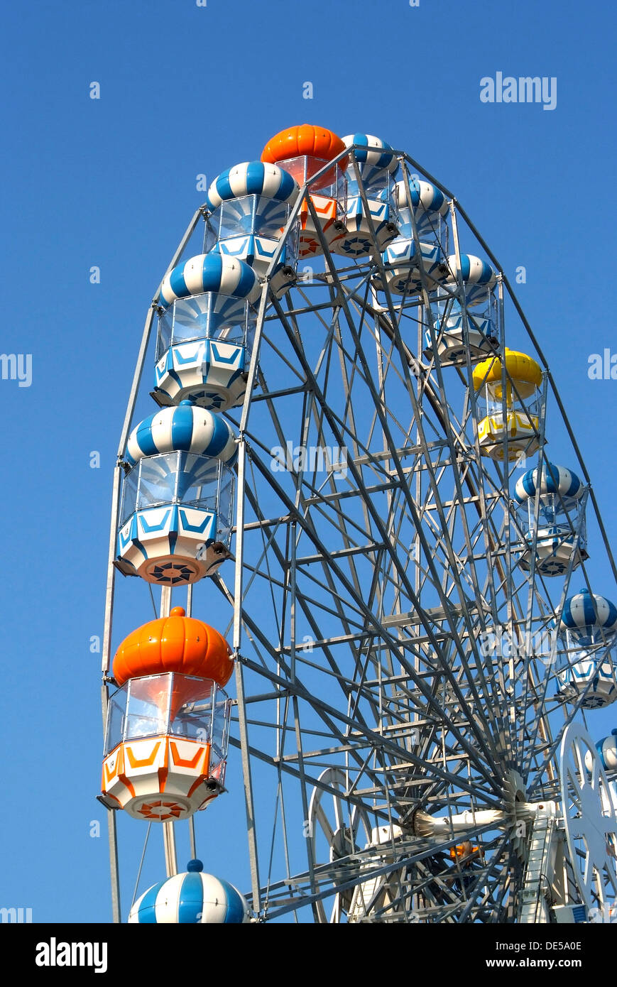 Colored Ferris wheel with blue sky background Stock Photo - Alamy