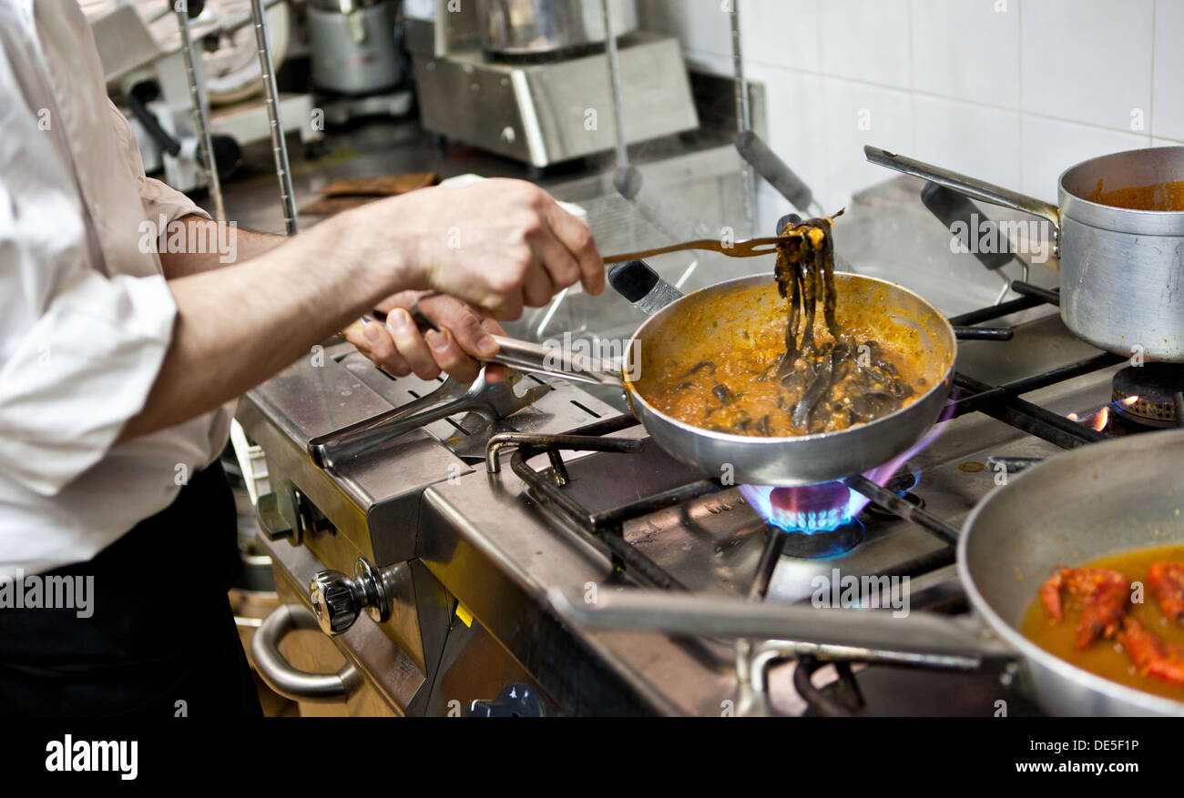 Food being prepared in a restaurant kitchen Stock Photo - Alamy