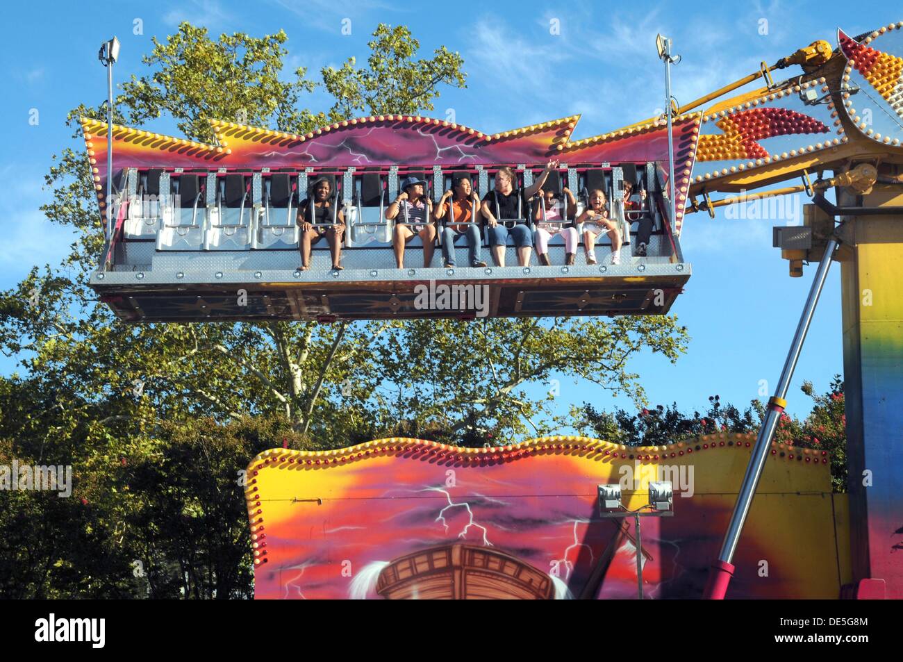 people enjoying a carnival ride Stock Photo - Alamy
