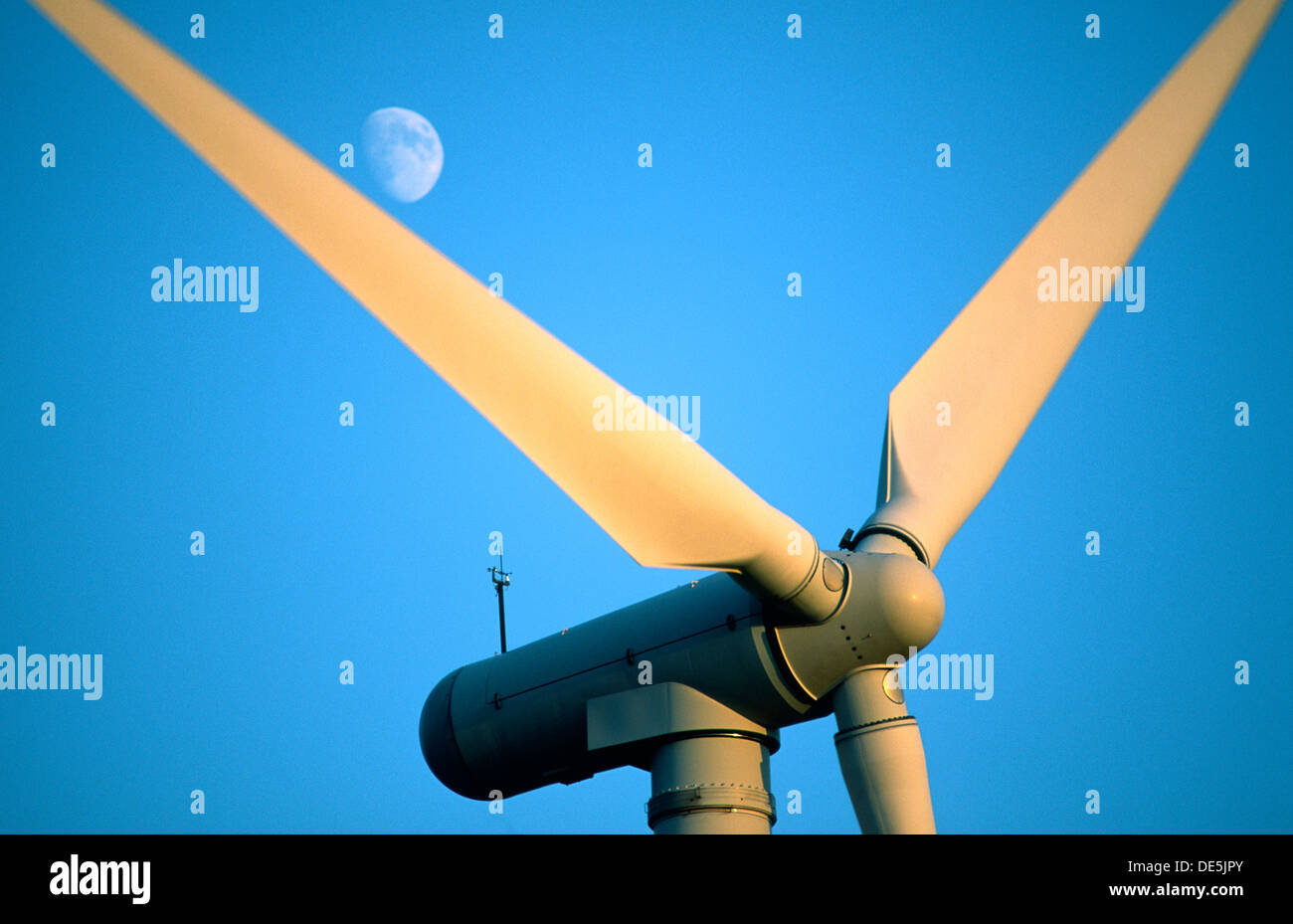 Wind turbine rotors with blue sky and moon generating electricity on ...