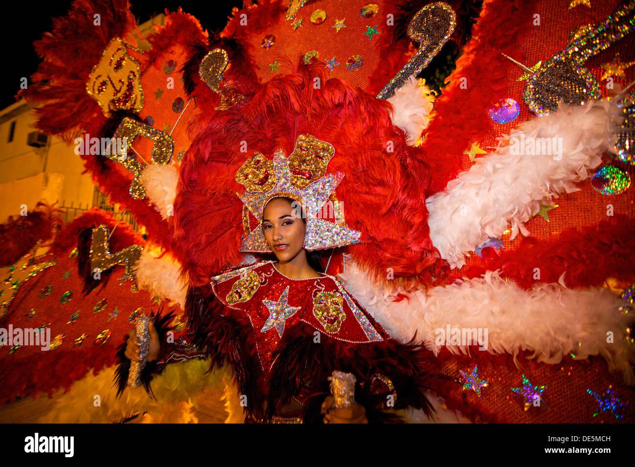 A costumed beauty queen dances in the streets during the Carnaval de ...