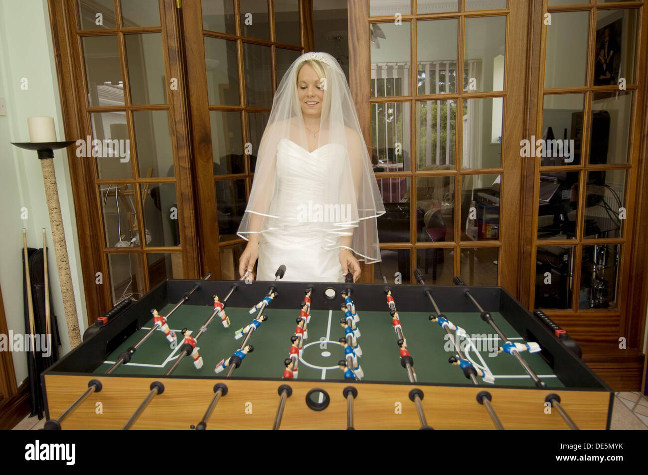 young bride on the morning of her wedding playing table football Stock ...