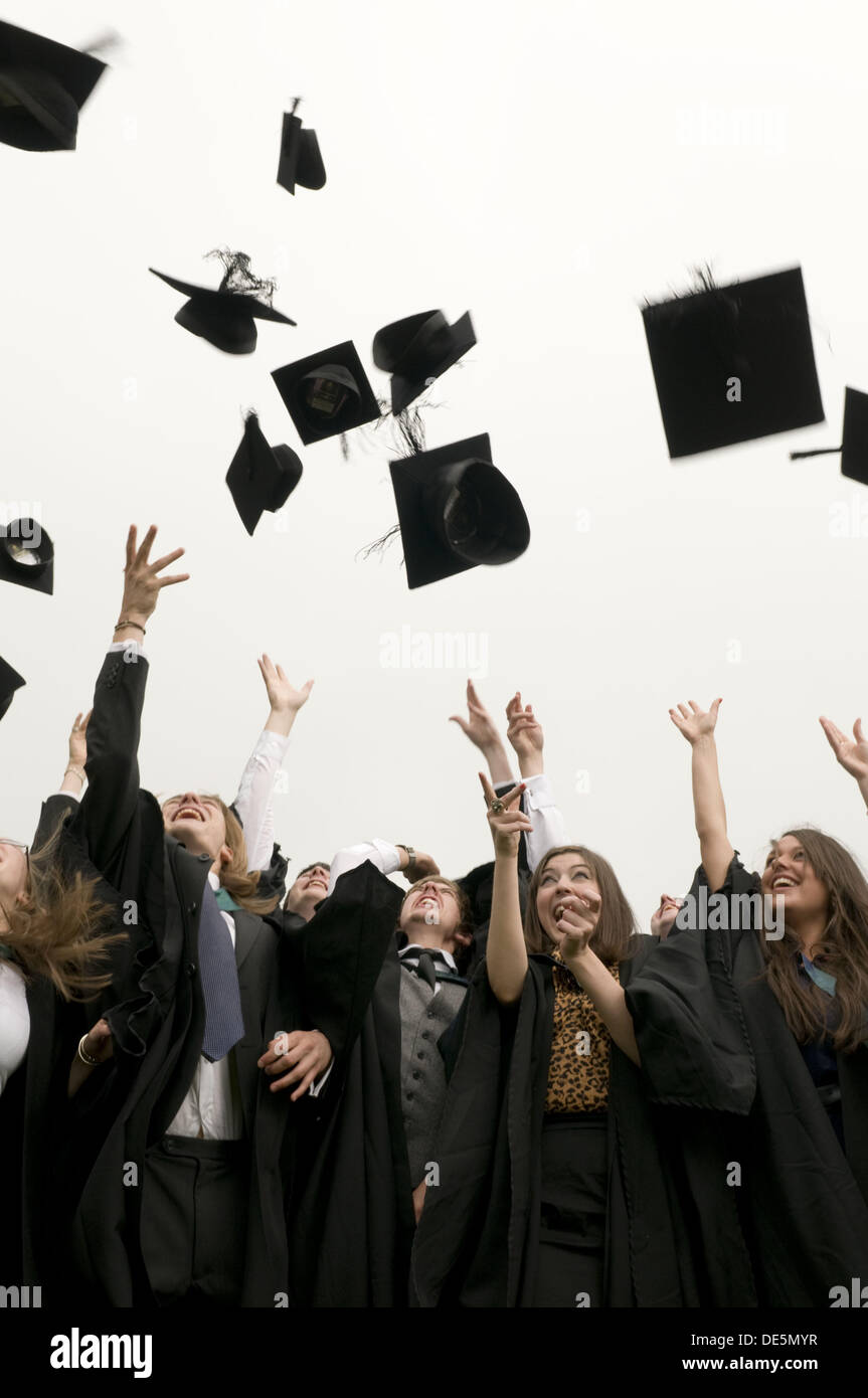 Students throwing caps in the air hi-res stock photography and images ...