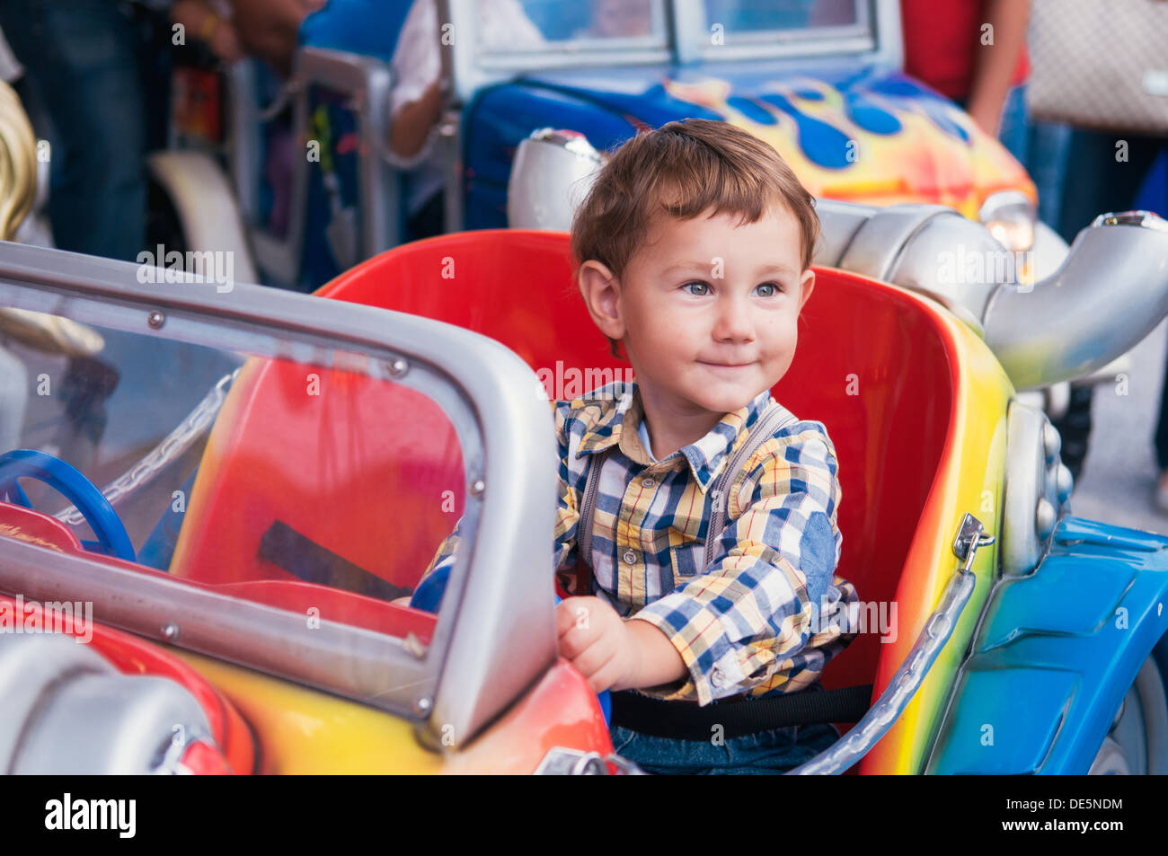 Little boy riding a car in amusement park Stock Photo - Alamy