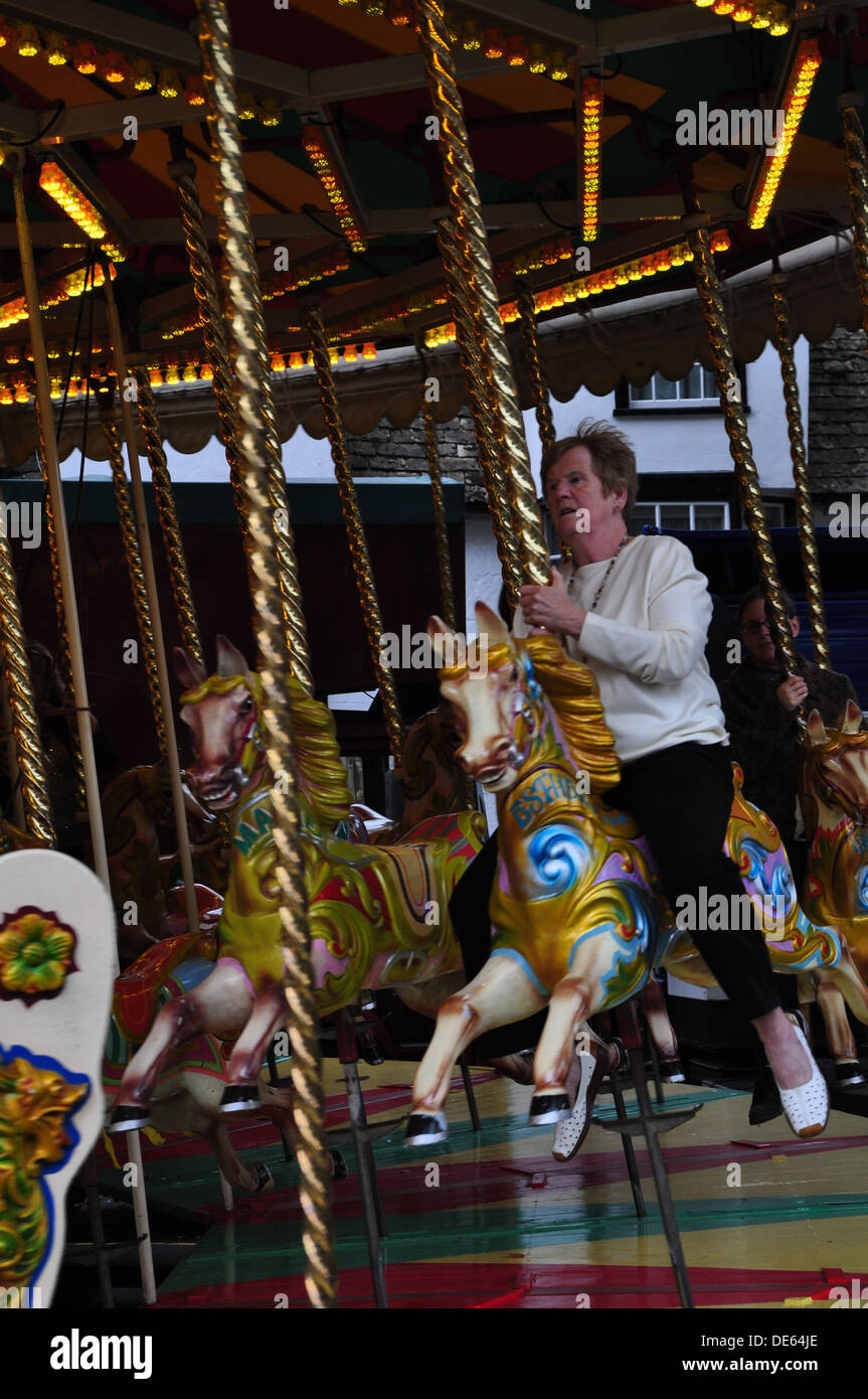 Elderly lady rides carousel, St. Giles fair, Oxford Stock Photo - Alamy