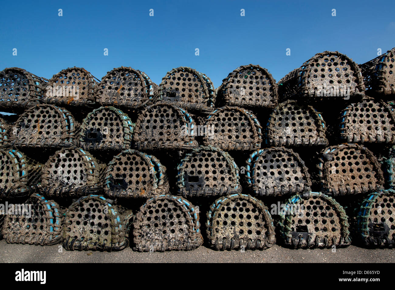 Lobster fishing pots stacked on the quayside of Ilfracombe harbour ...