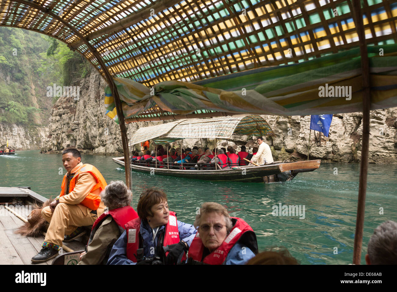 Tourist boats taking tourists up the Daning River through Three Gorges ...