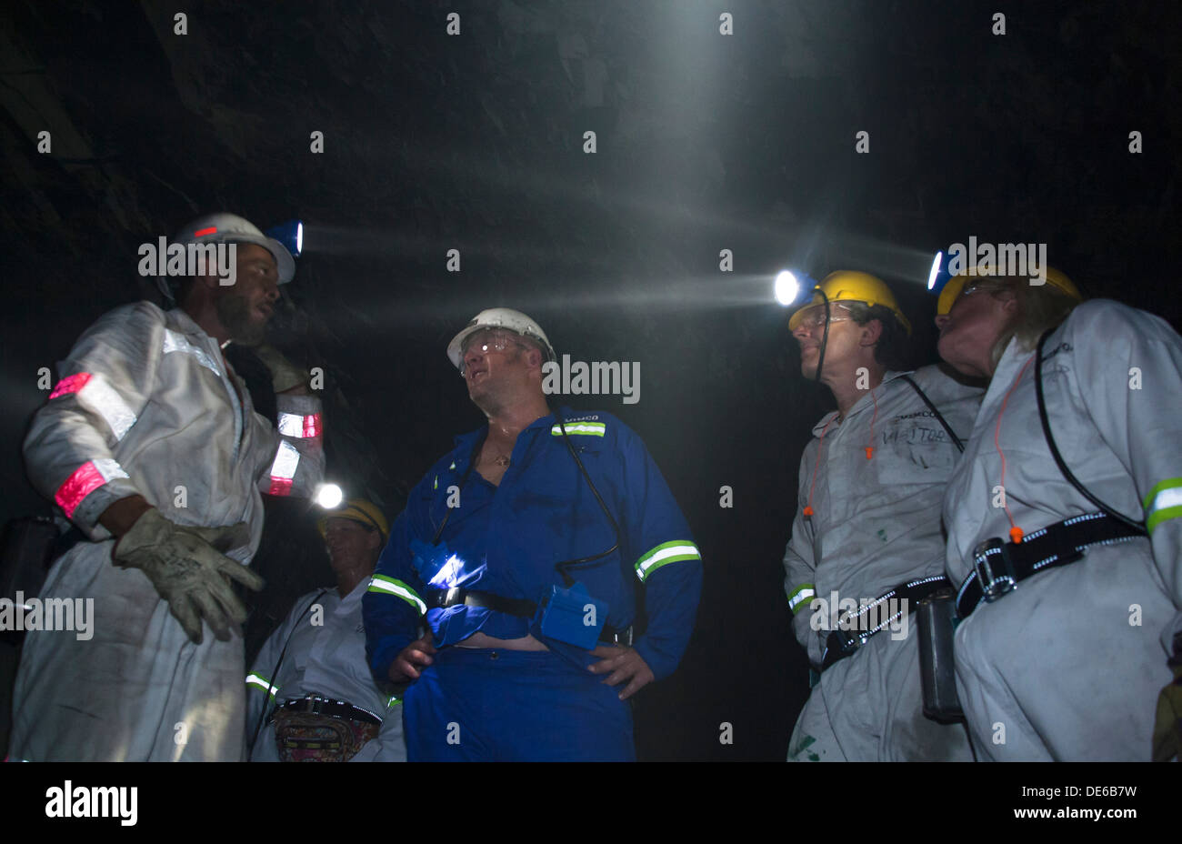 Visitors on a guided gold mine tour listening to the mining process ...