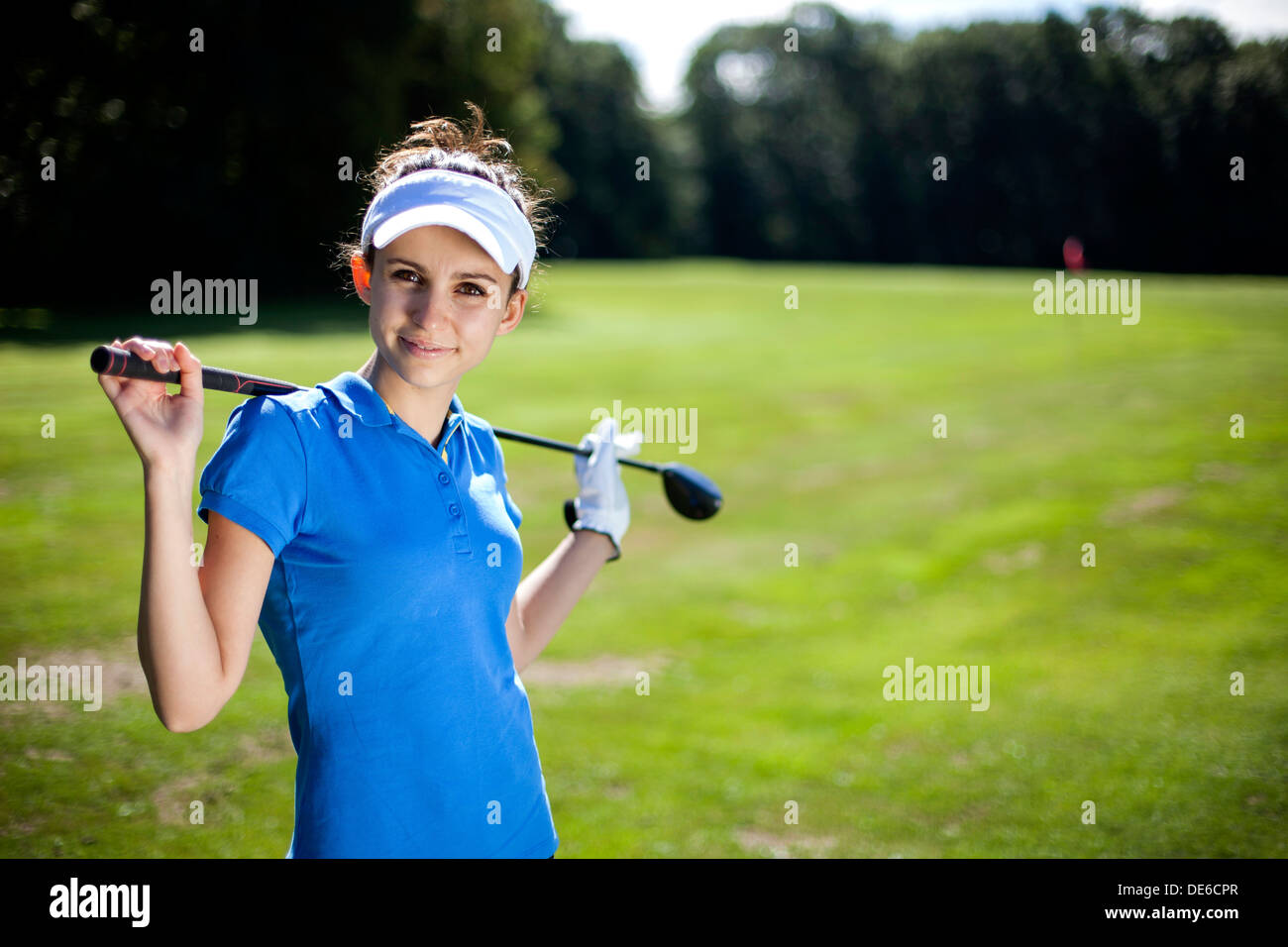 Portrait of a woman playing golf in summer Stock Photo - Alamy