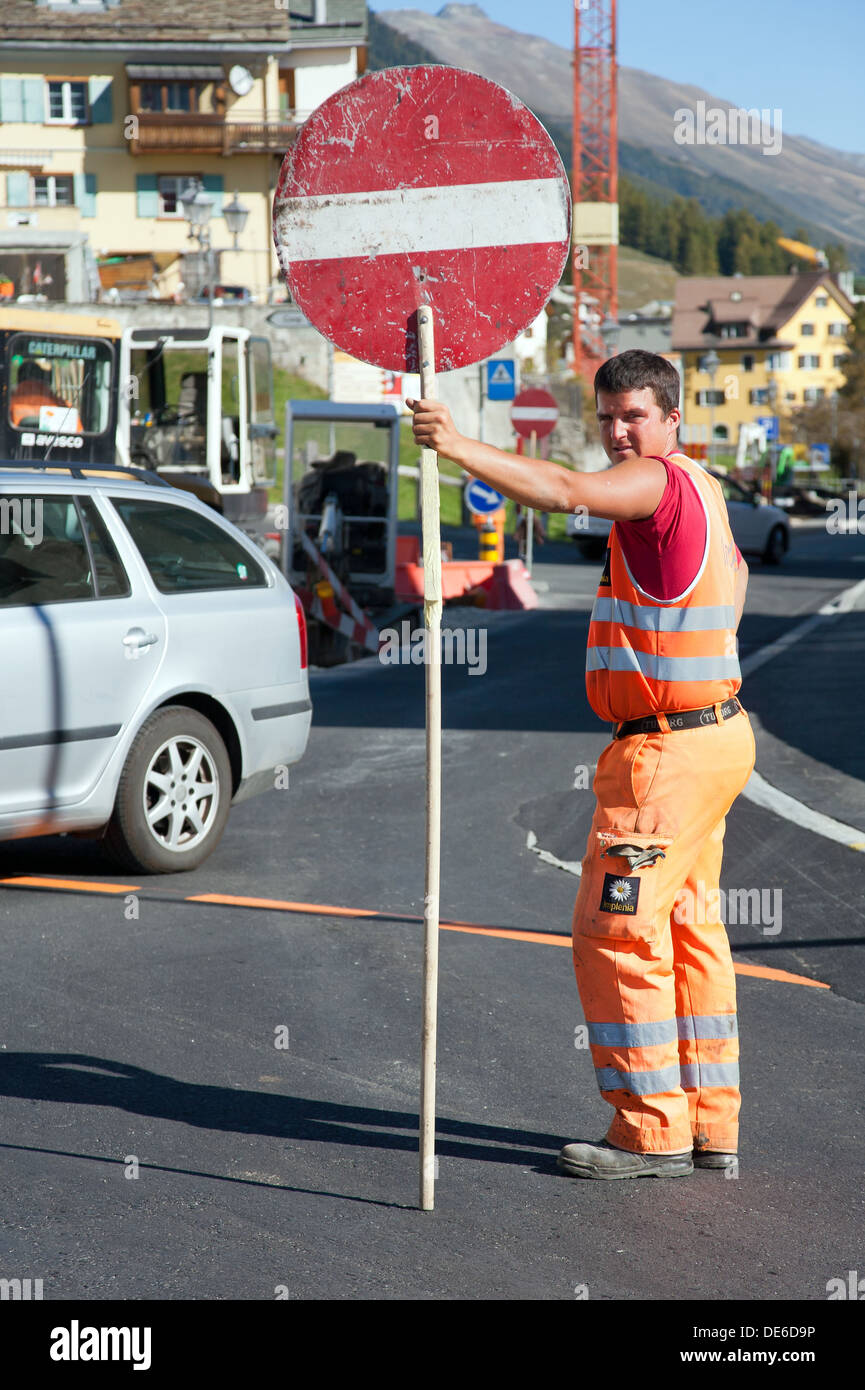 Samedan, Switzerland, construction worker directing traffic a road ...