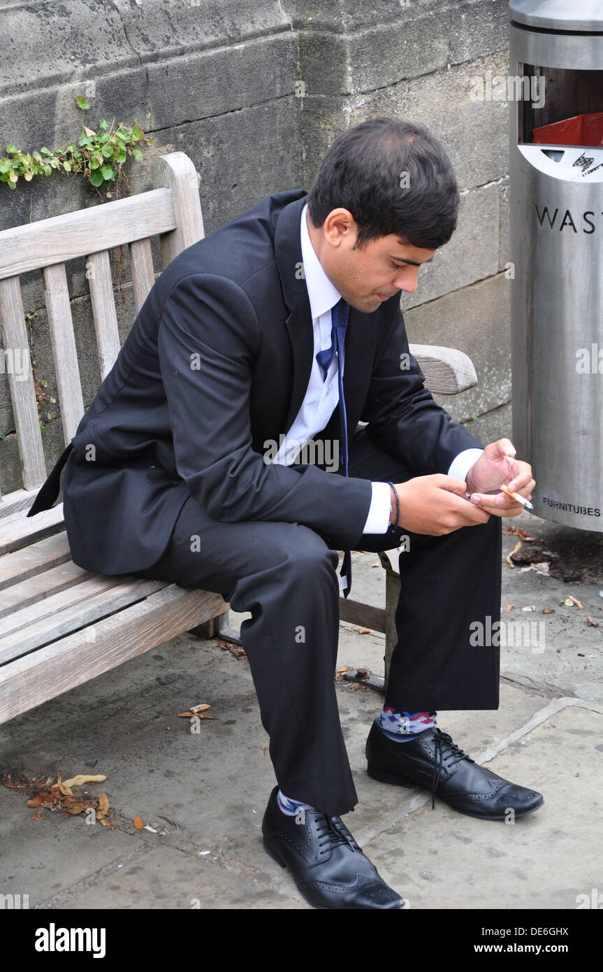 Smoking using phone hi-res stock photography and images - Alamy