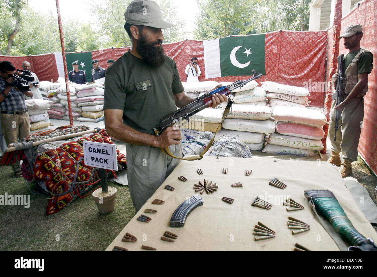 Security officials inspect recovered 6000 kg packets of drug (Charas ...