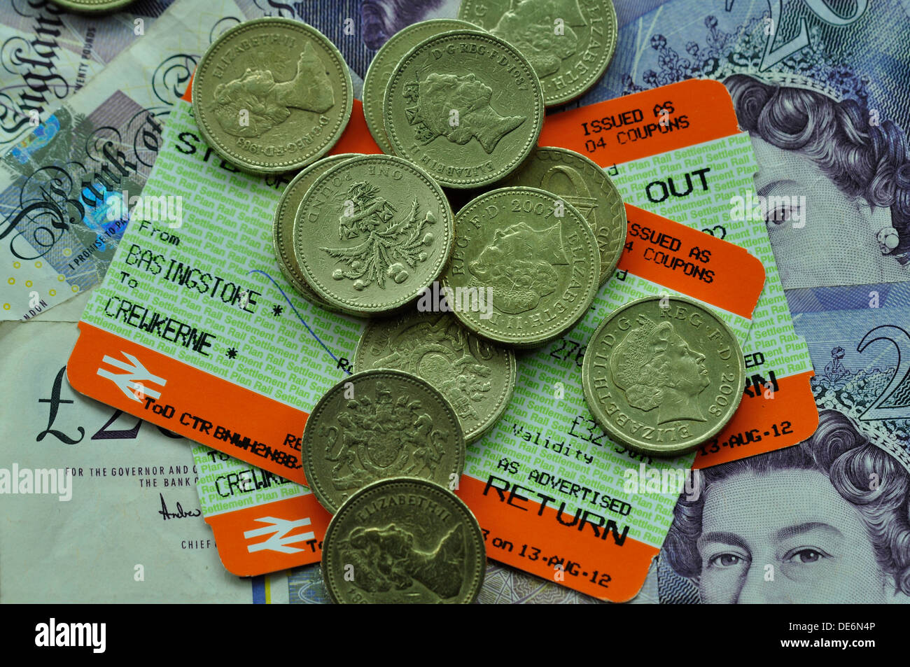 Rail tickets with lots of money - notes and pound coins UK Stock Photo ...