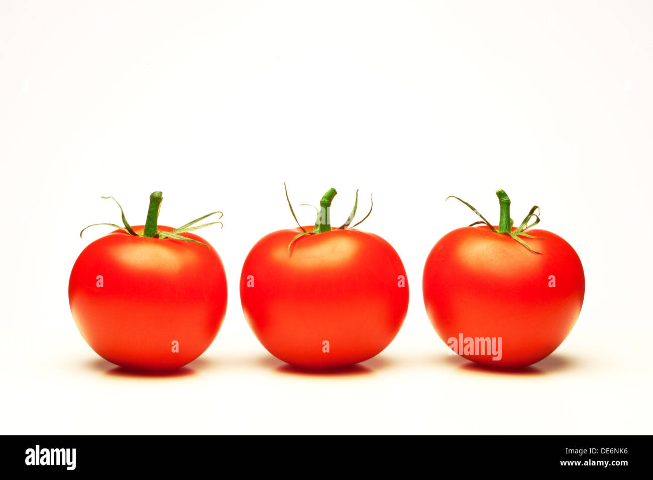 Three tomatoes. White background Stock Photo - Alamy