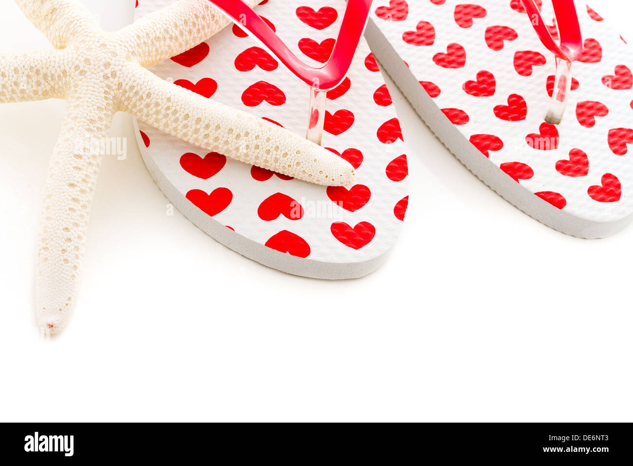 Star sea shell with flip flops on a white background Stock Photo - Alamy