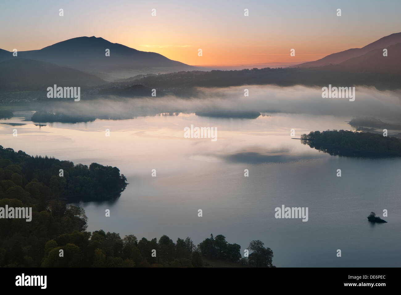 View over Derwentwater from Catbells at sunrise with mist rolling down ...